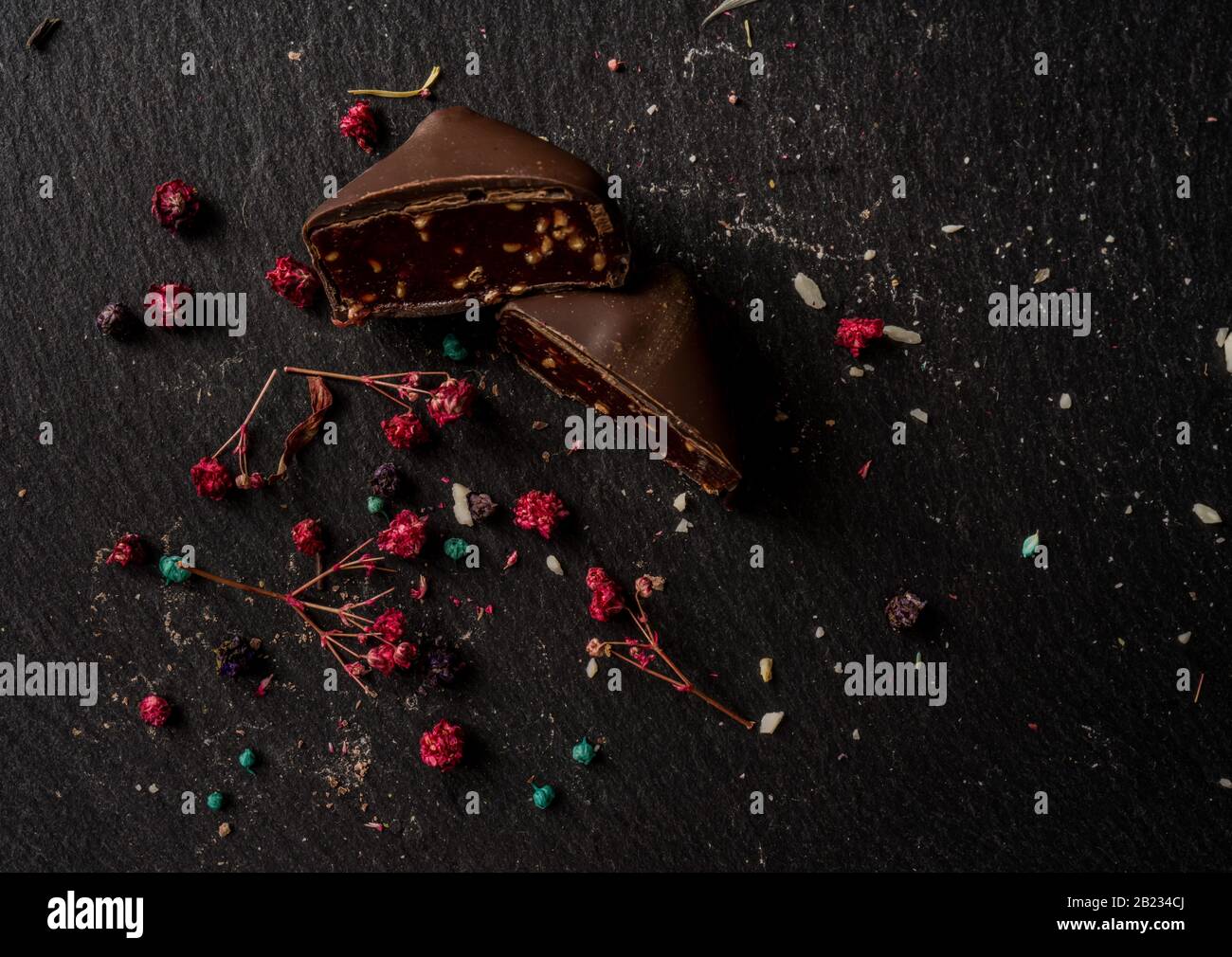 Homemade dried dewberry Belgian chocolates on dark background Stock ...