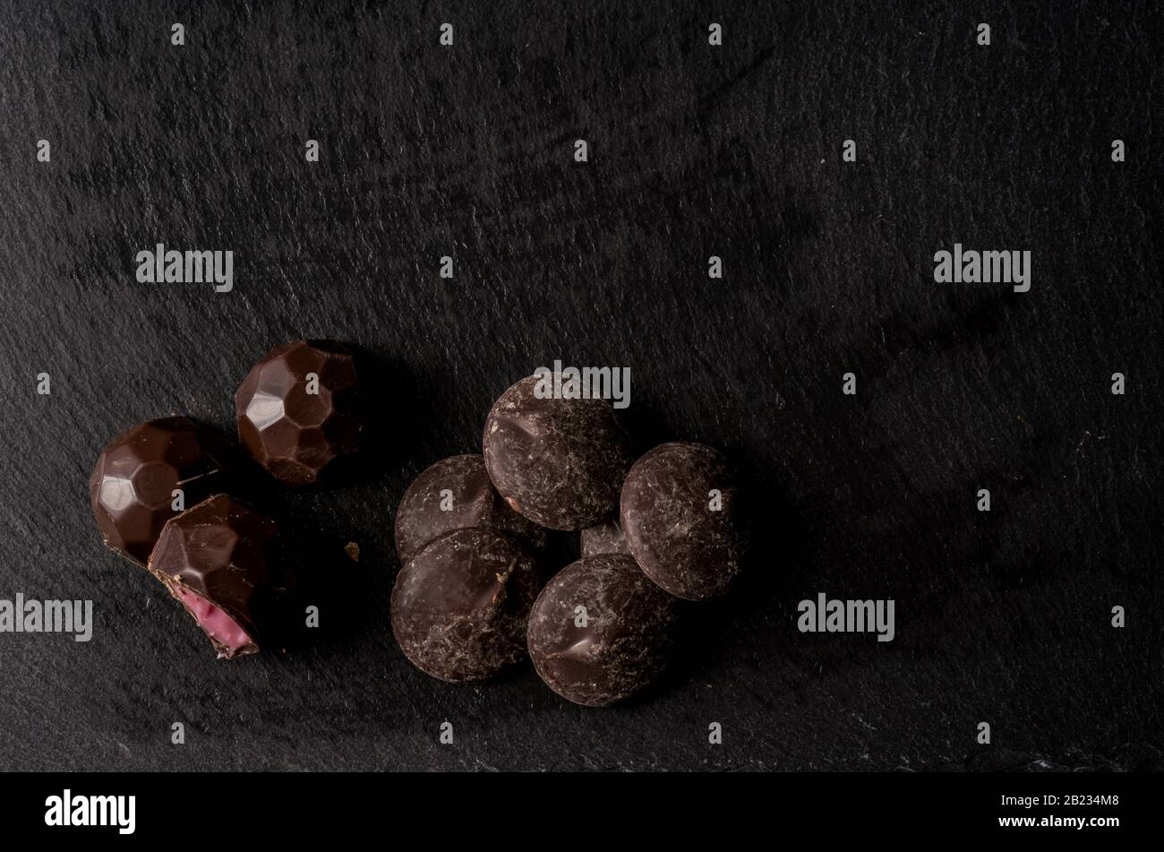 Homemade dried dewberry Belgian chocolates on dark background Stock ...