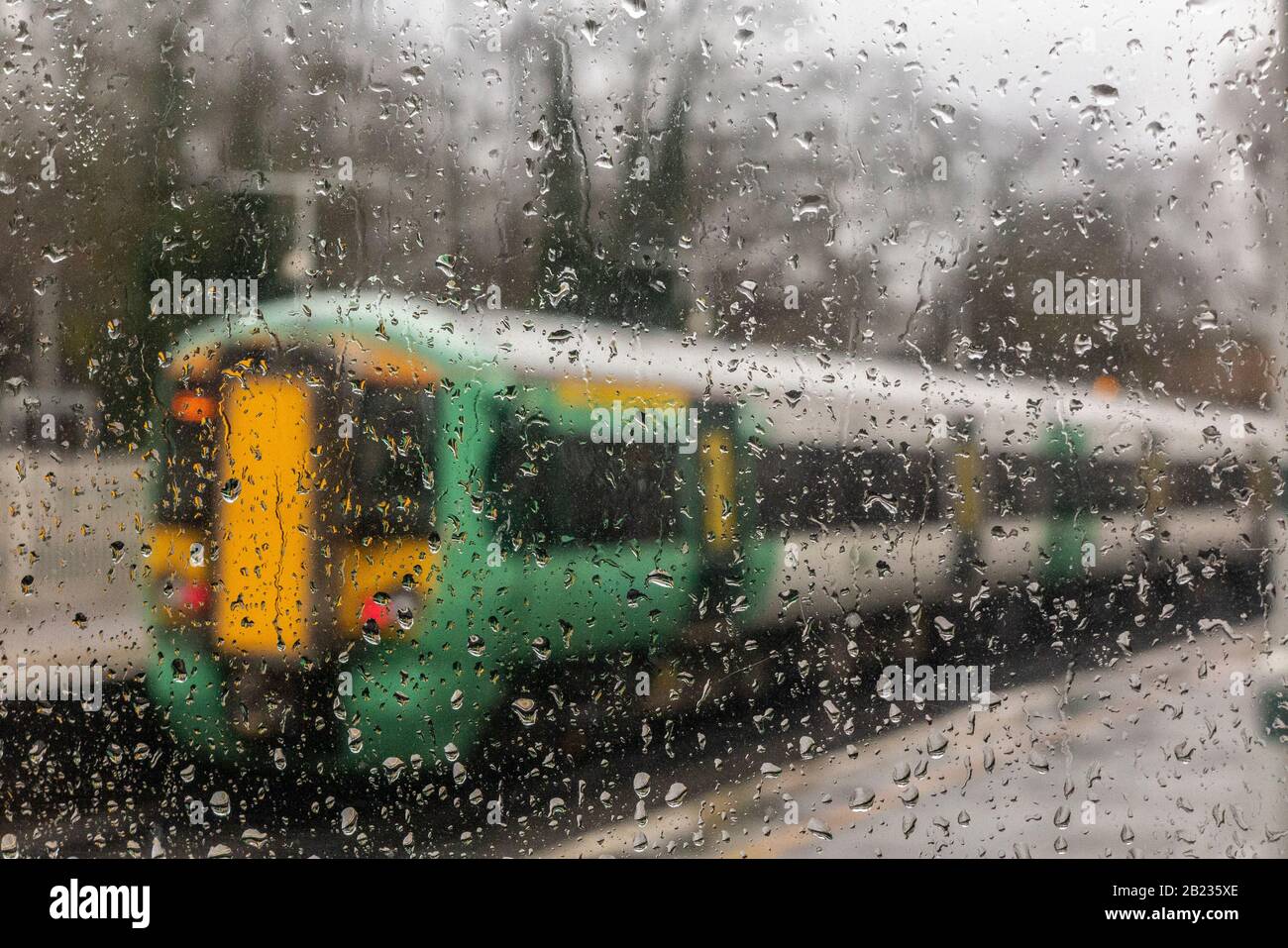 A southern railway commuter train on a miserable, rainy, stormy winter ...