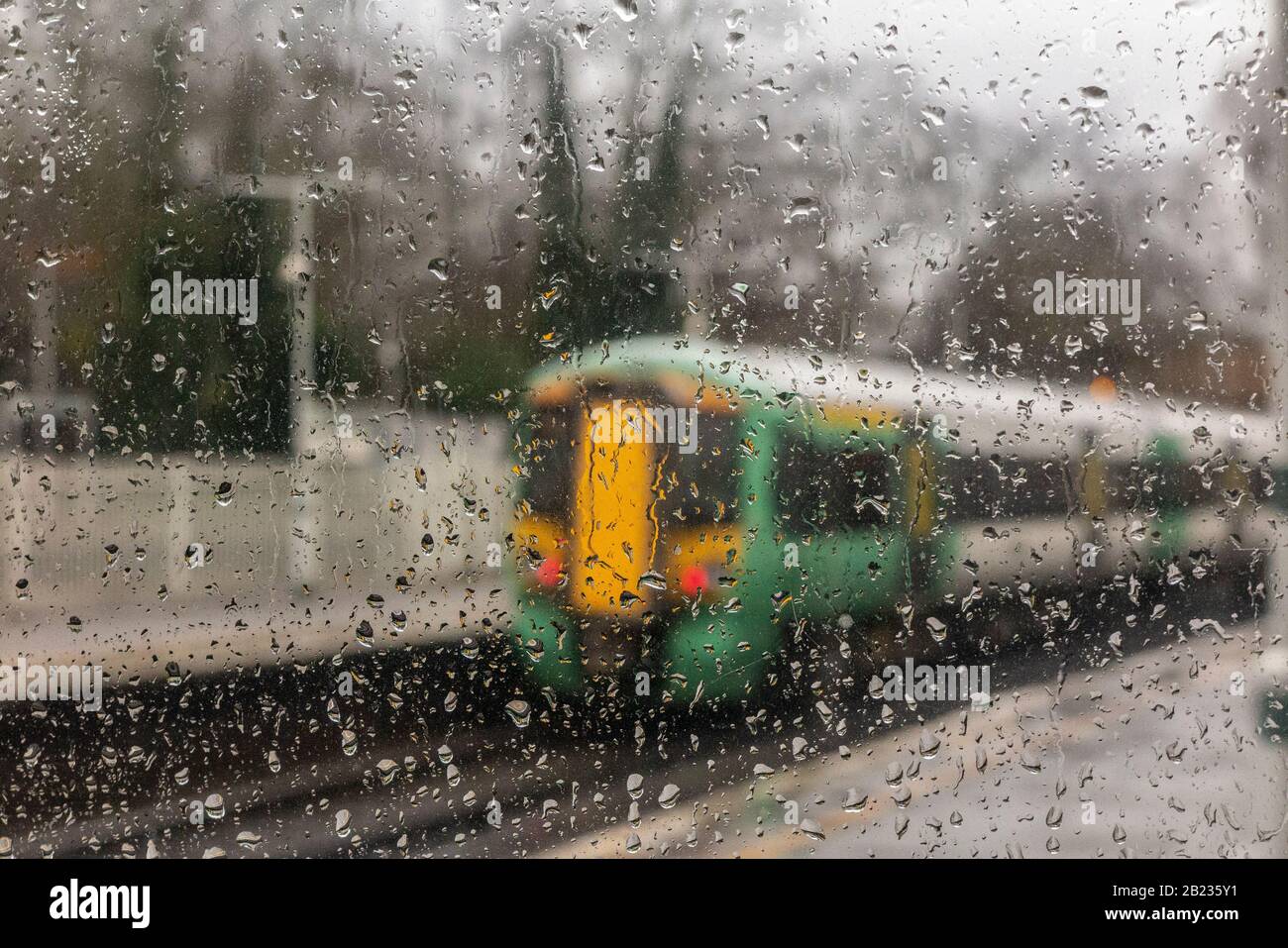 A southern railway commuter train on a miserable, rainy, stormy winter ...