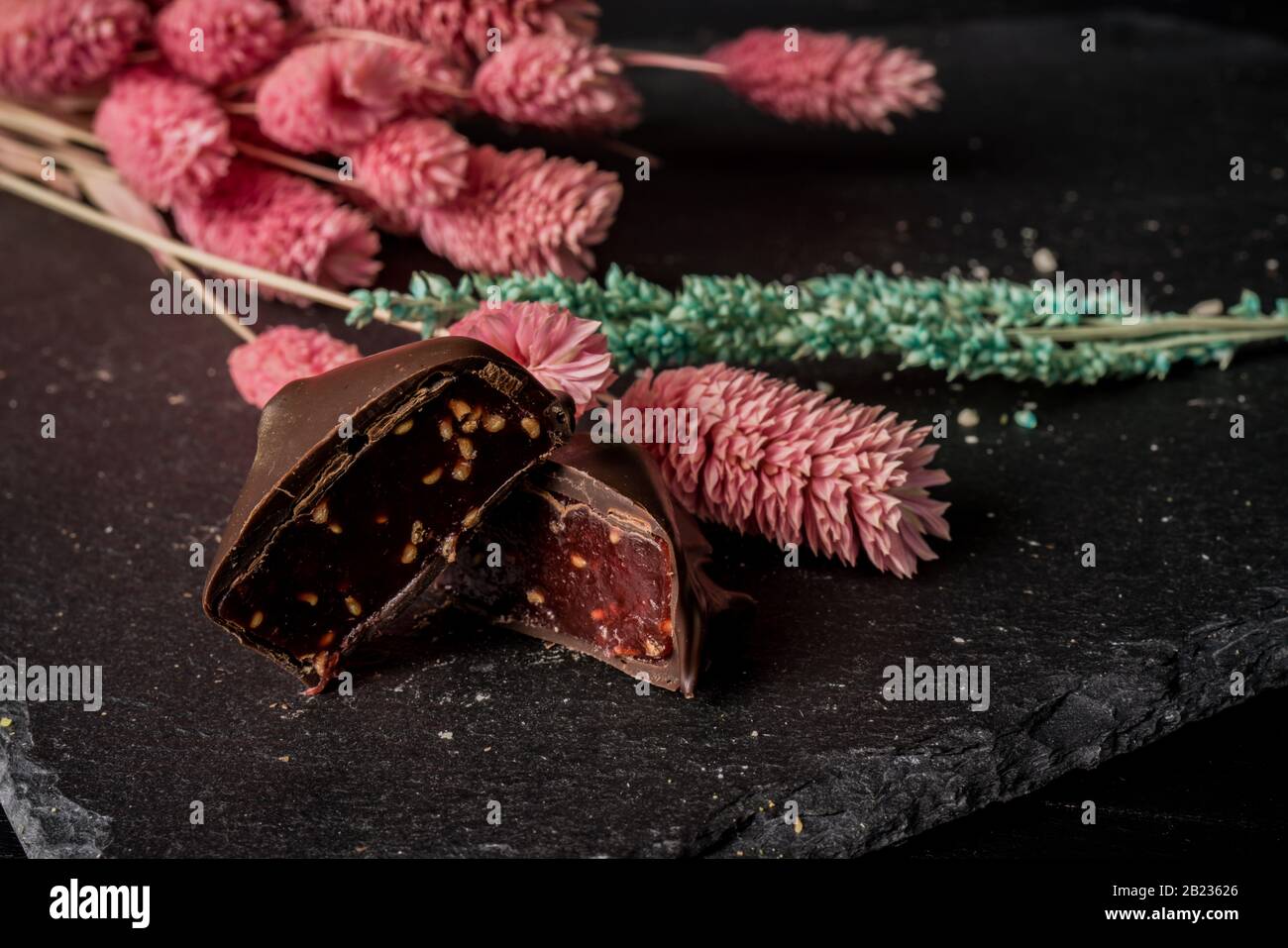 Homemade dried dewberry Belgian chocolates on dark background Stock ...