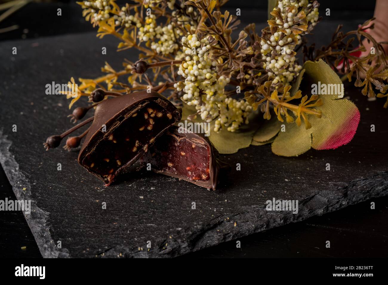 Homemade dried dewberry Belgian chocolates on dark background Stock ...