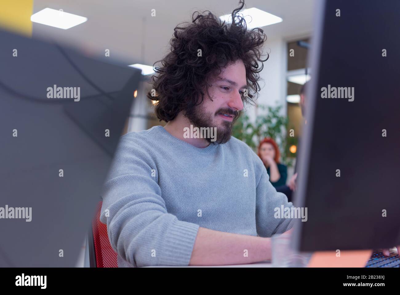 Young male web developer working and brainstorming about business plan ...