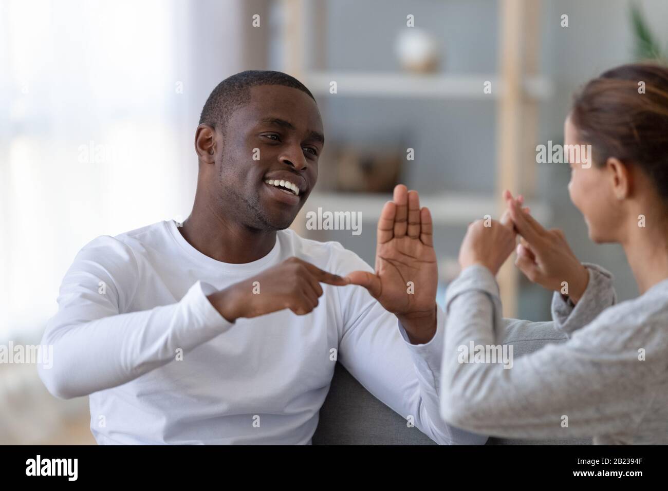 Smiling African American man and woman speaking sign language Stock ...