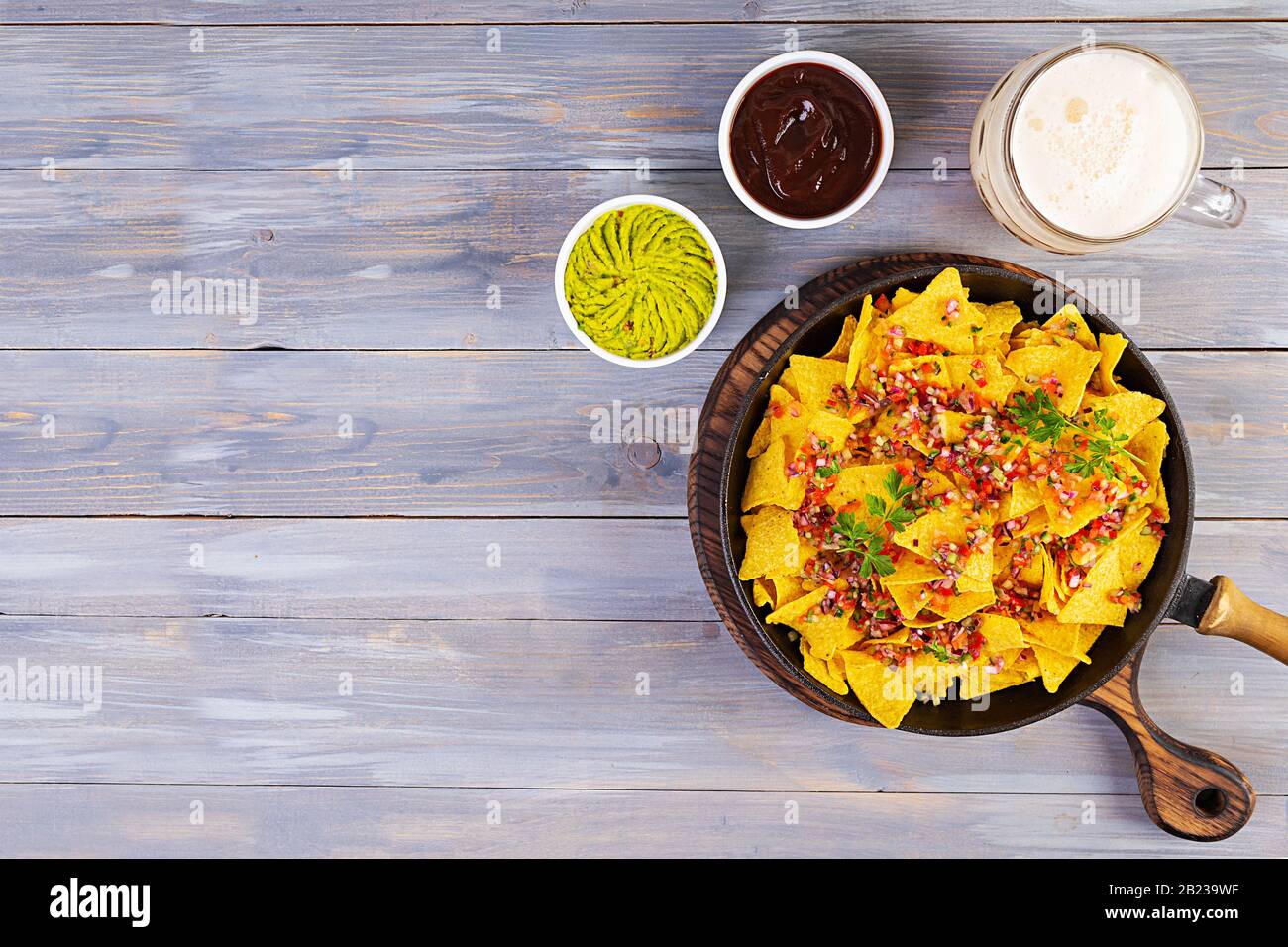 Mexican nachos with cheese. Corn chips with guacamole, salsa and tomato ...