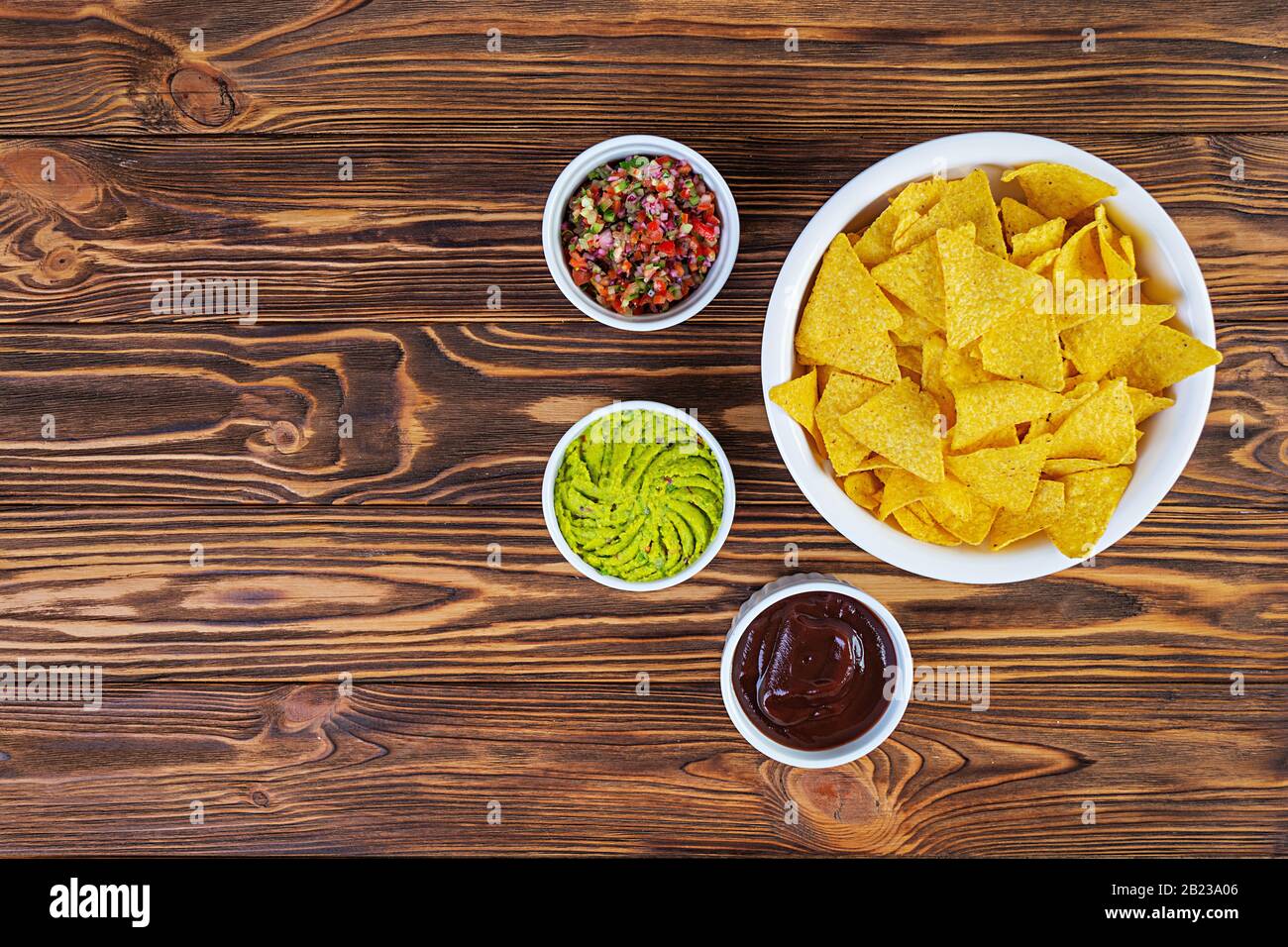 Mexican nachos with cheese. Corn chips with guacamole, salsa and tomato ...