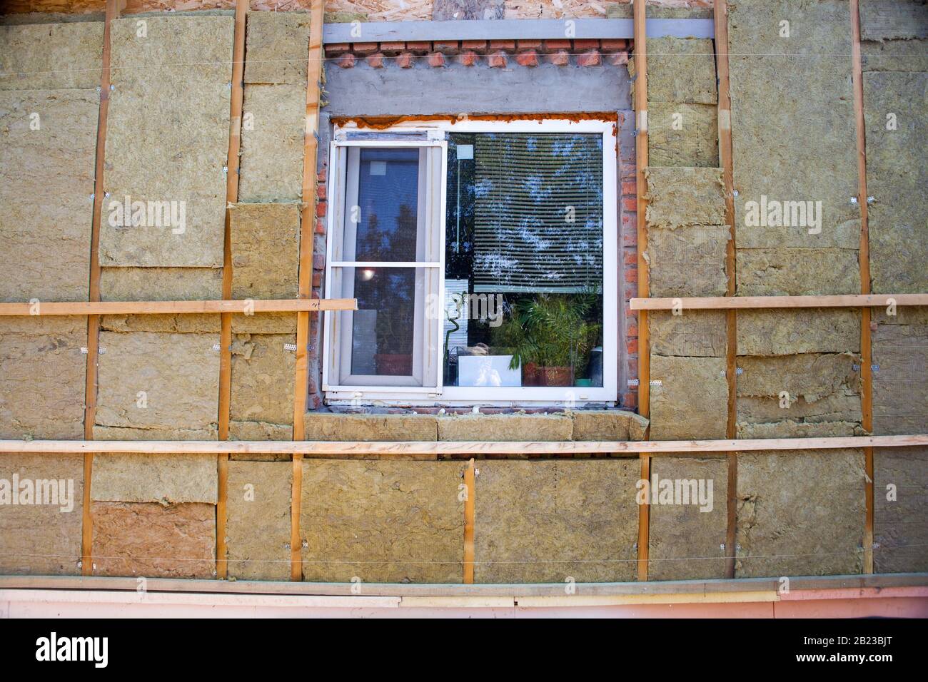 warming the walls of a stone house with a stone wool heater. Ecological ...