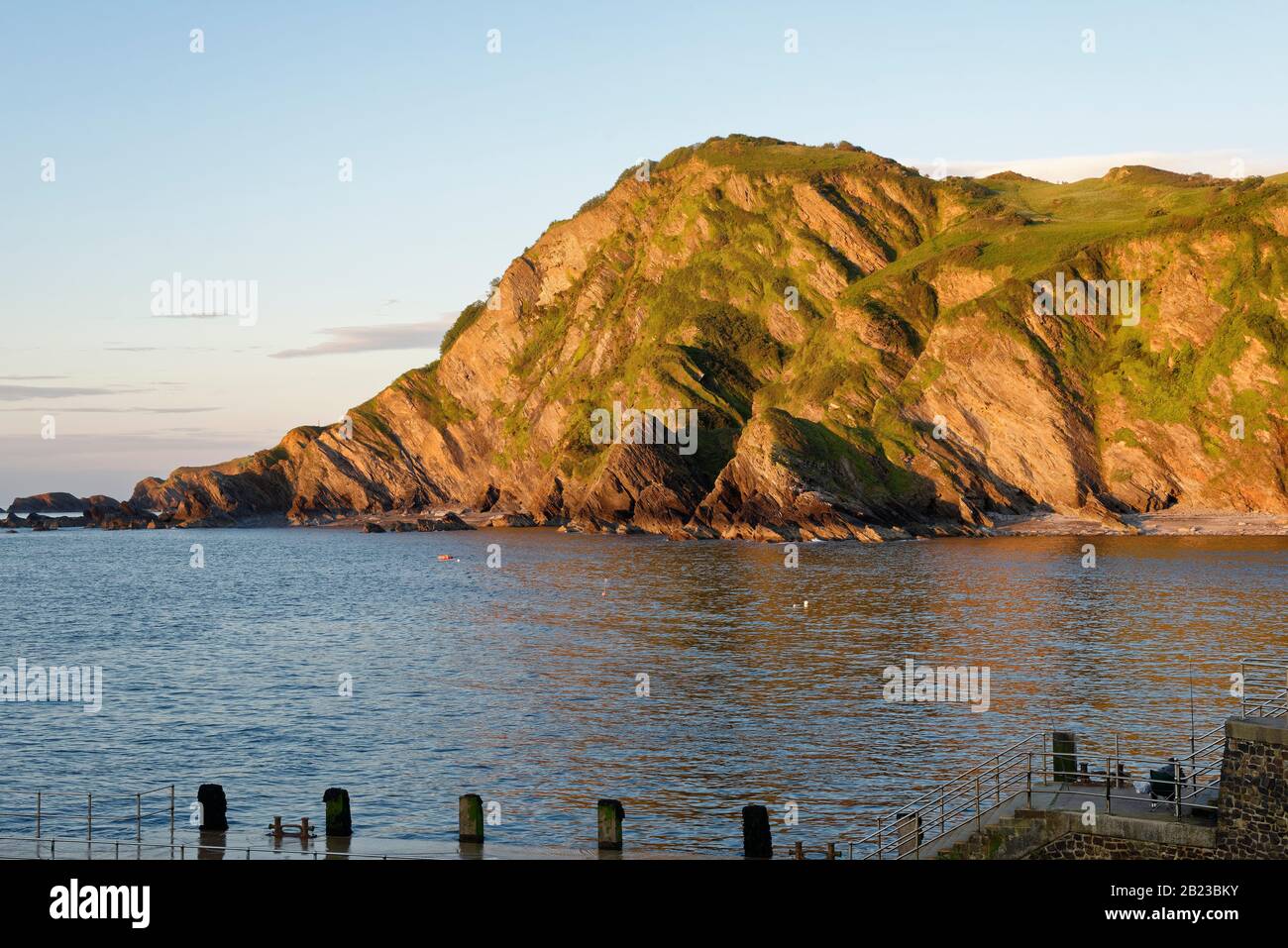 Late Sun on Beacon Point viewed from Harbour, Ilfracombe, Devon, UK ...