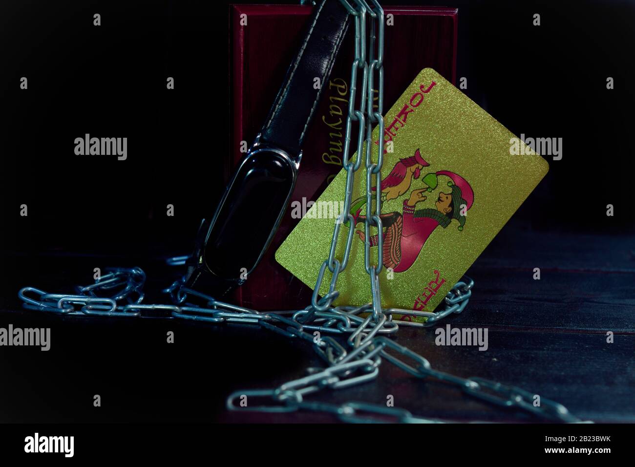 joker card and a box was locked by chain Stock Photo - Alamy