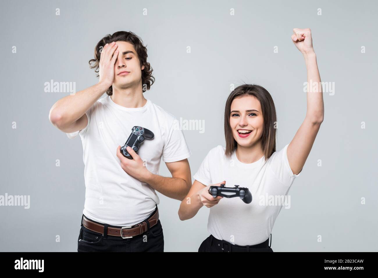Full length portrait of a young attractive couple standing isolated ...