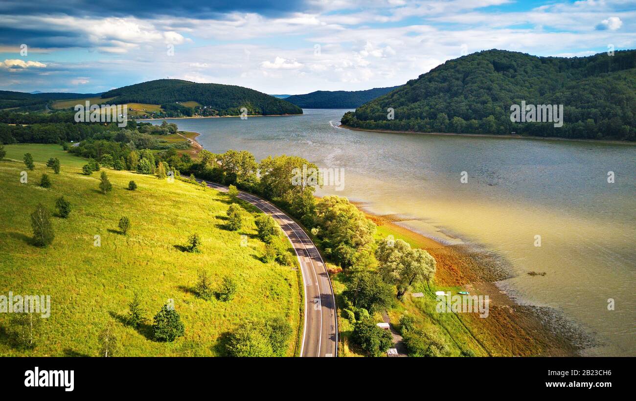 Summer landscape with lake and mountains. Road on the lakeside. Aerial ...
