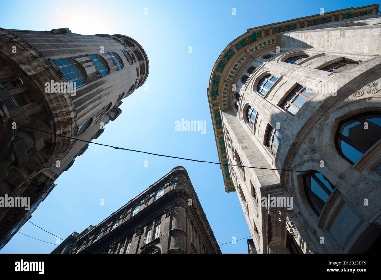 View from below at an intersection of old rounded buildings in Istanbul ...