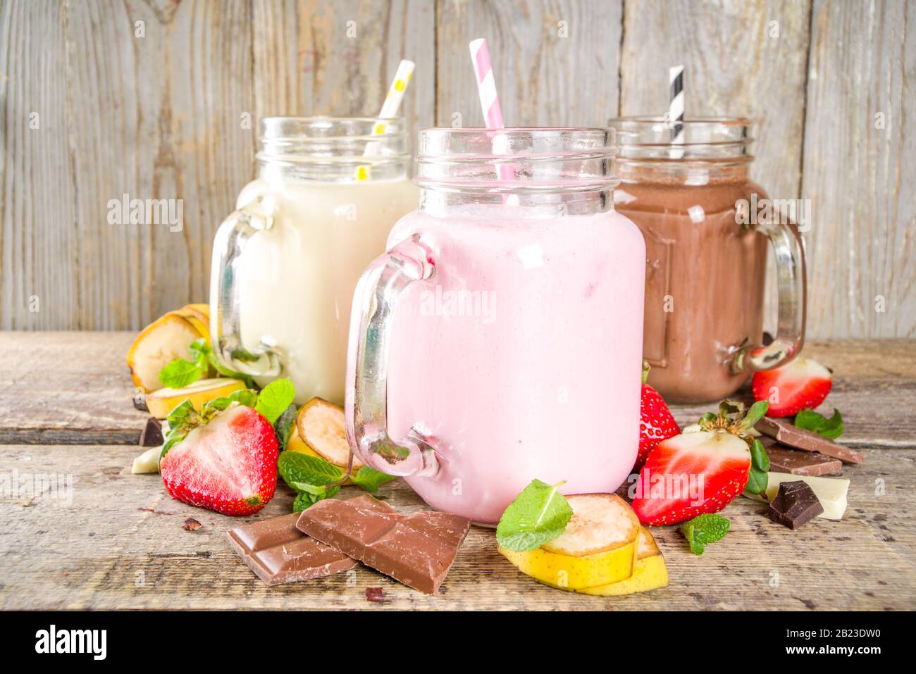 Three mason jars with milkshakes or smoothie. Summer healthy breakfast ...