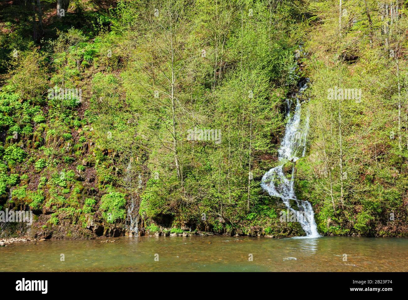 waterfall from the forest on the hill. beautiful nature scenery in ...