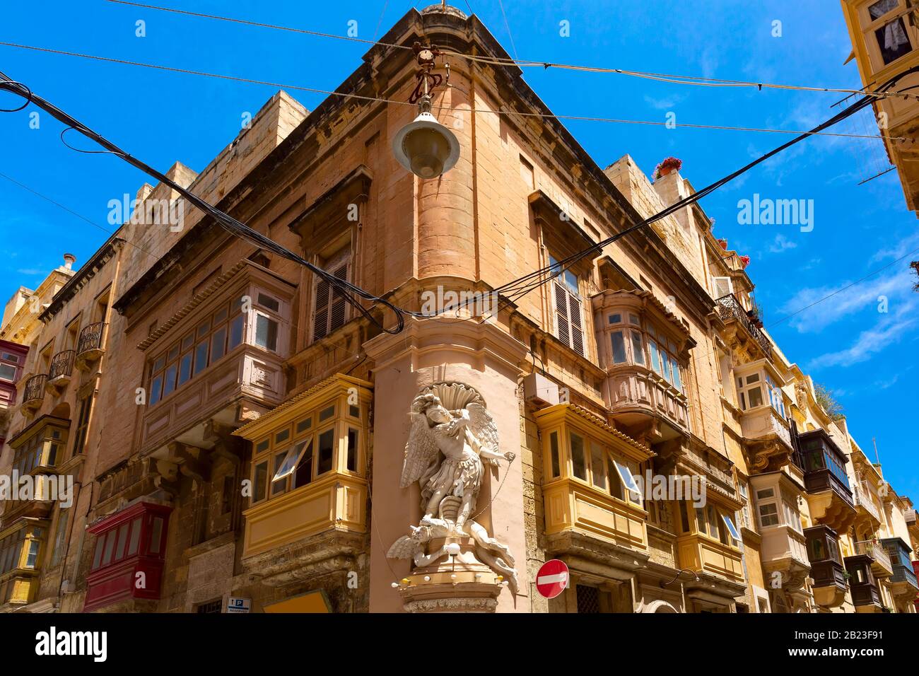 The traditional Maltese street with corners of houses, decorated with ...
