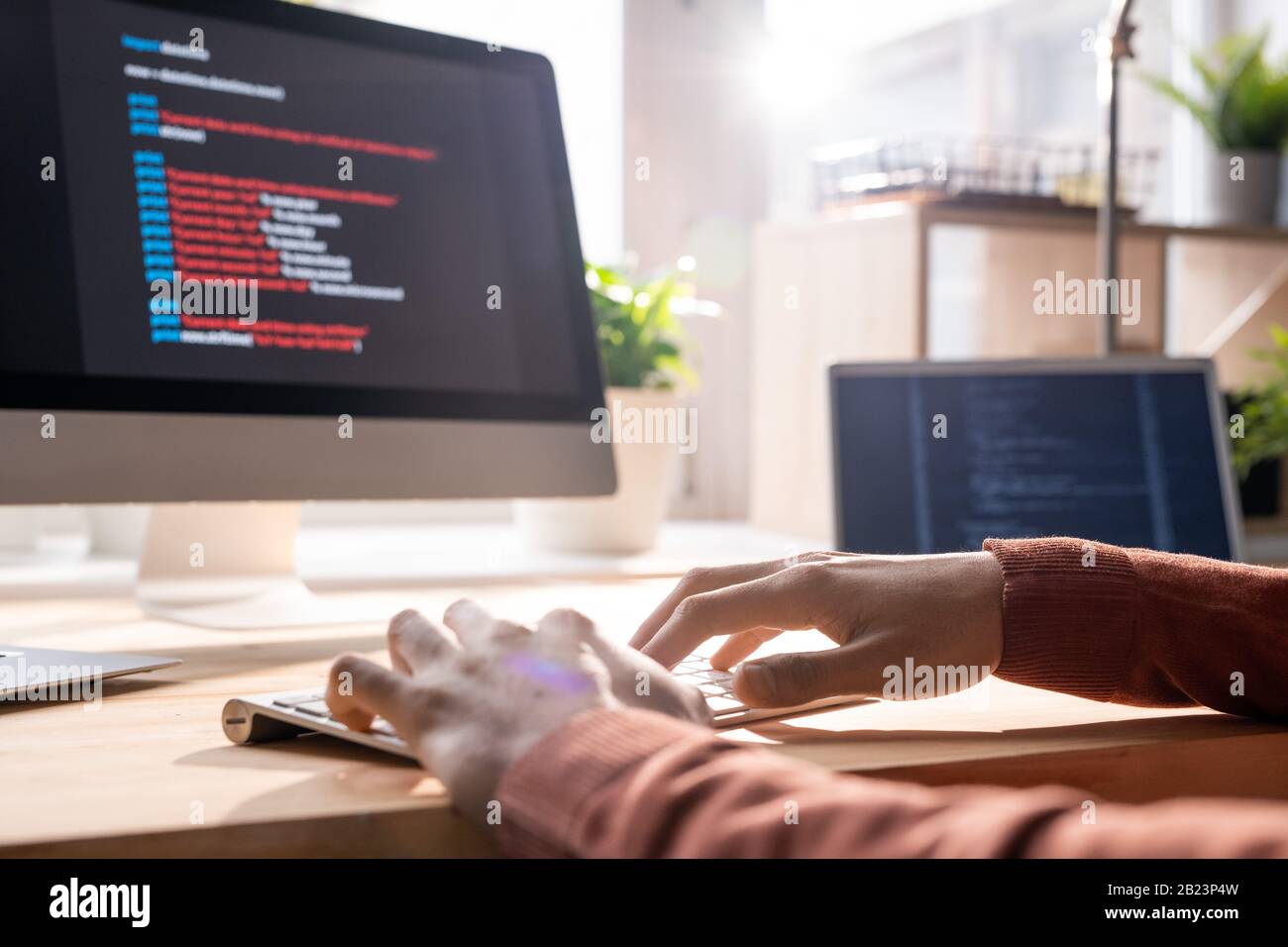 Hands of young contemporary programmer over keypad during work over new ...