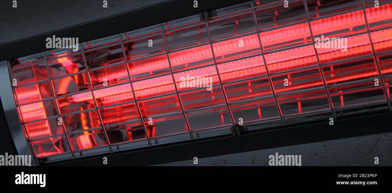 a switched on infrared heater on a house wall Stock Photo - Alamy