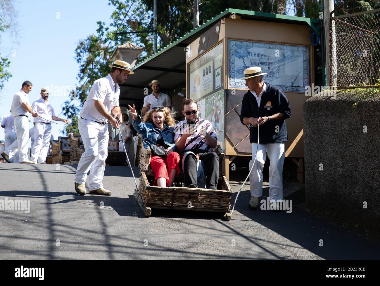 People enjoy the Monte Toboggan Ride in Madeira Stock Photo - Alamy
