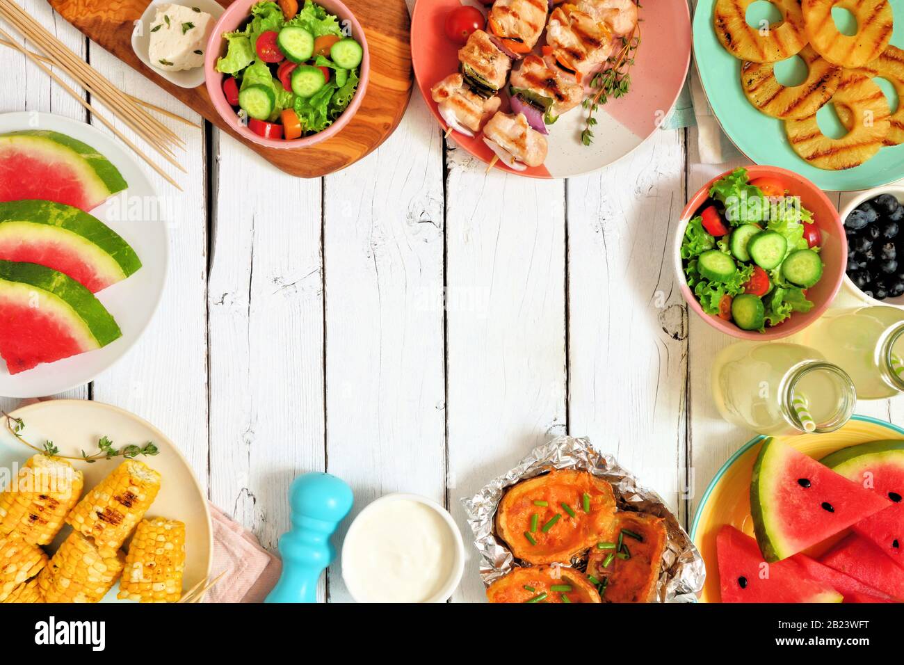 Summer BBQ or picnic food frame. Selection of grilled meat, fruits ...