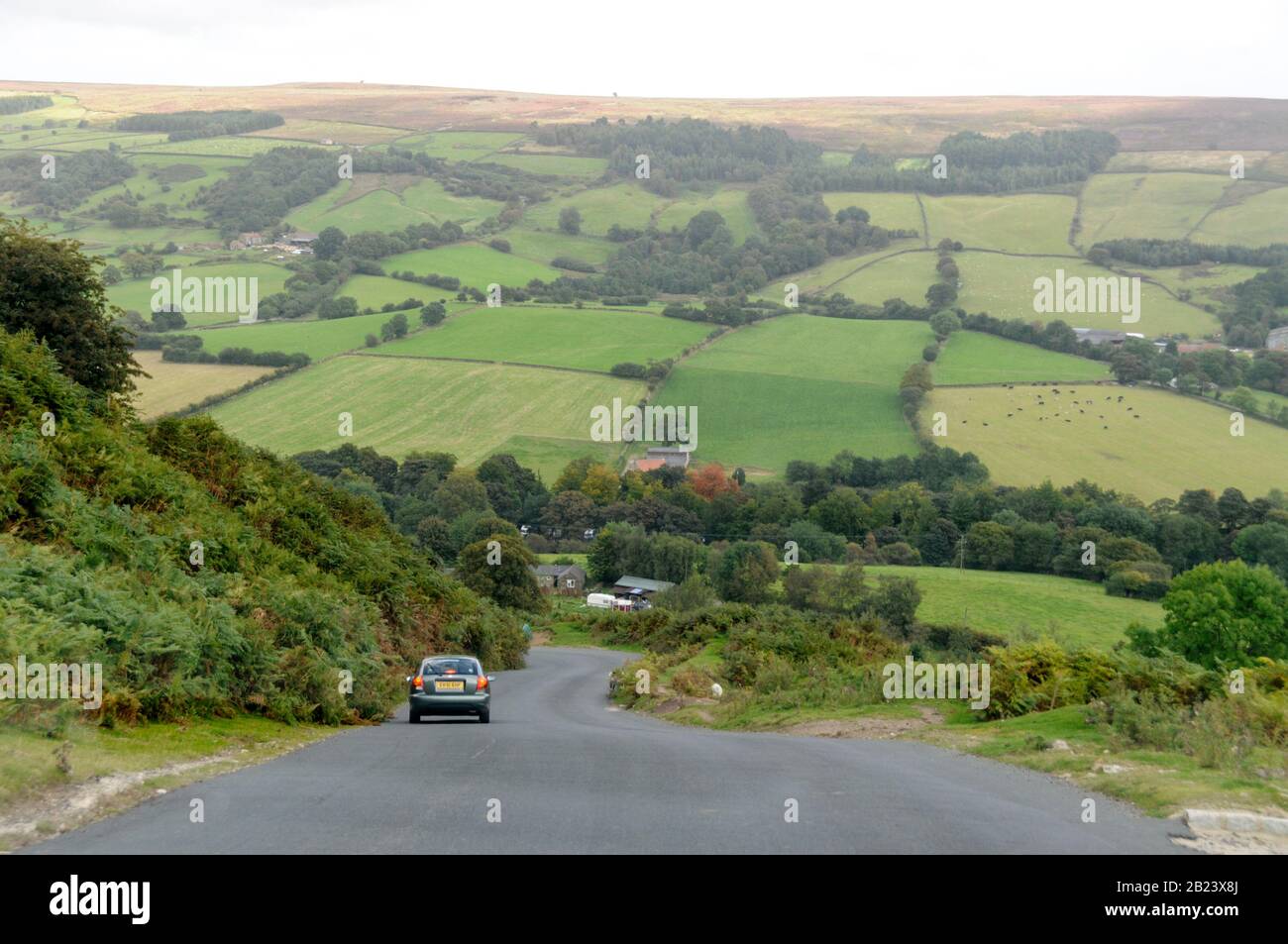 A car descends one of England’s steepest minor roads with a gradient of ...