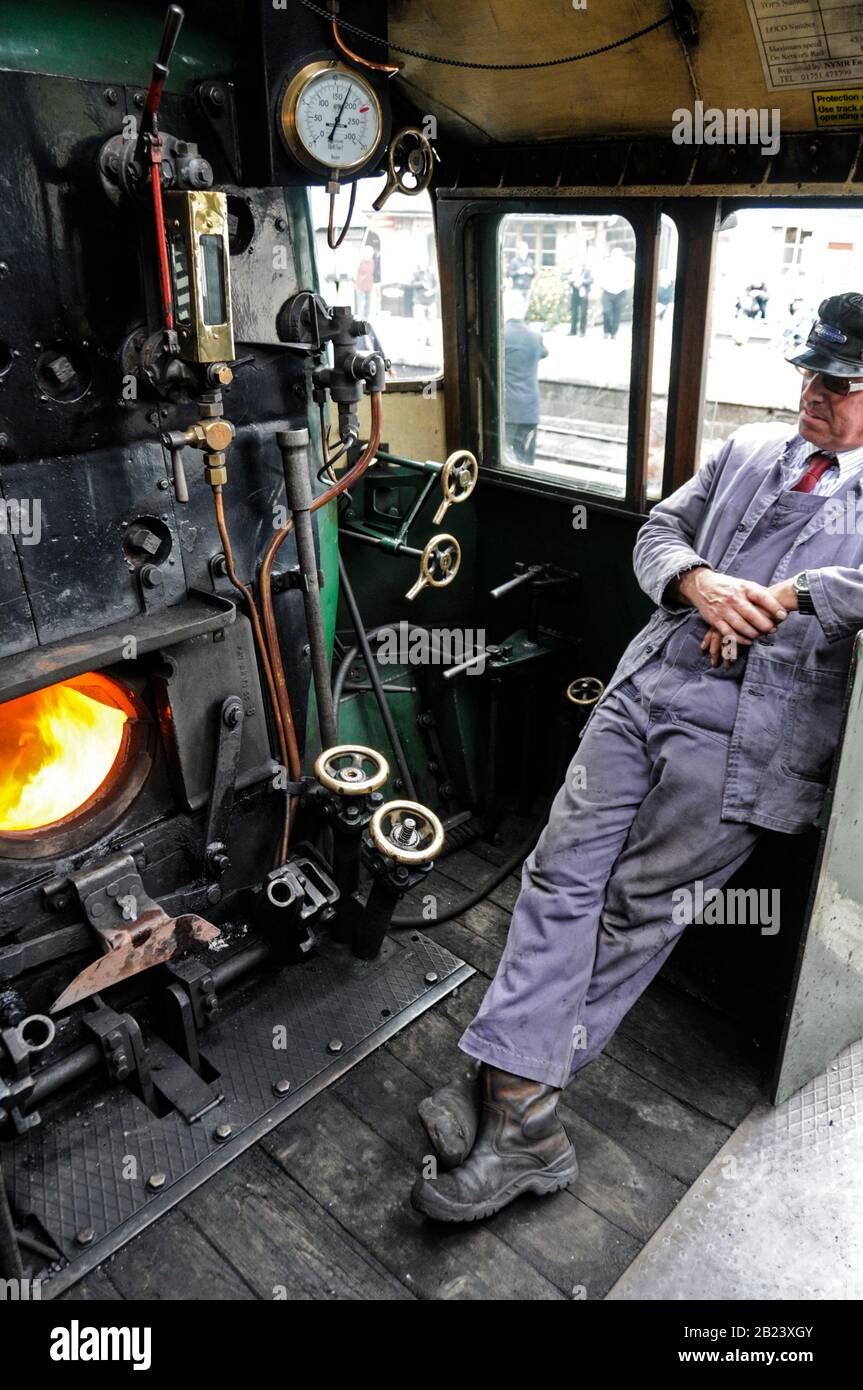 A steam engine driver on the footplate of the steam locomotive, No ...