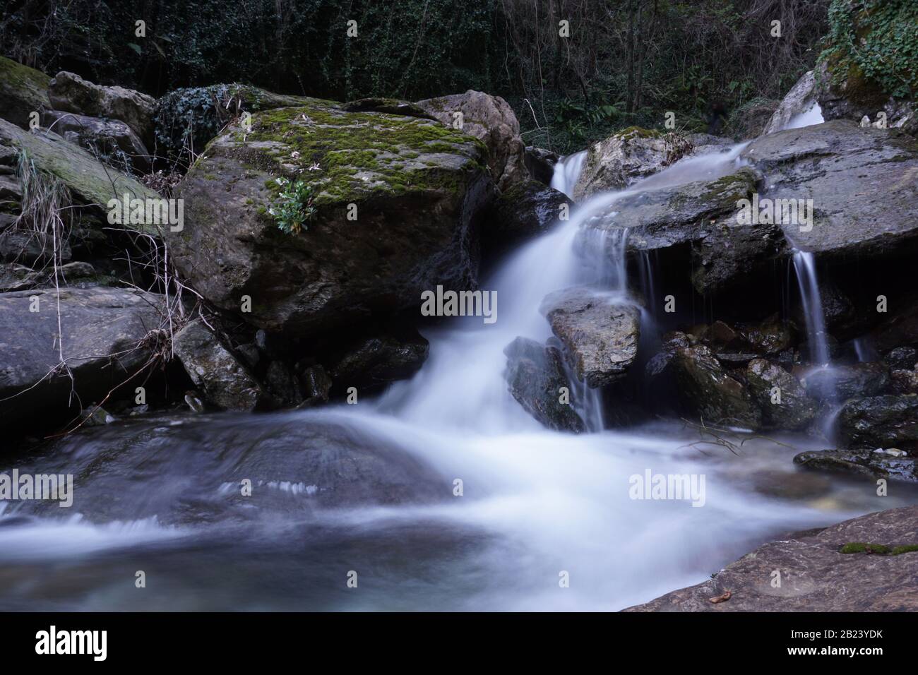 Water flows into a mountain river Stock Photo - Alamy