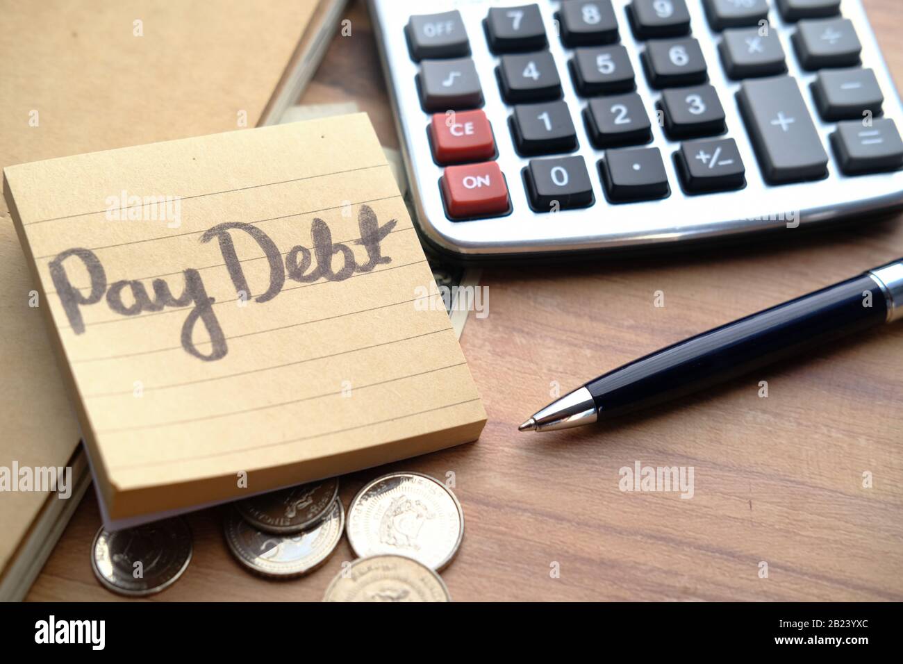 pay debt concept with cash and coin Stock Photo - Alamy