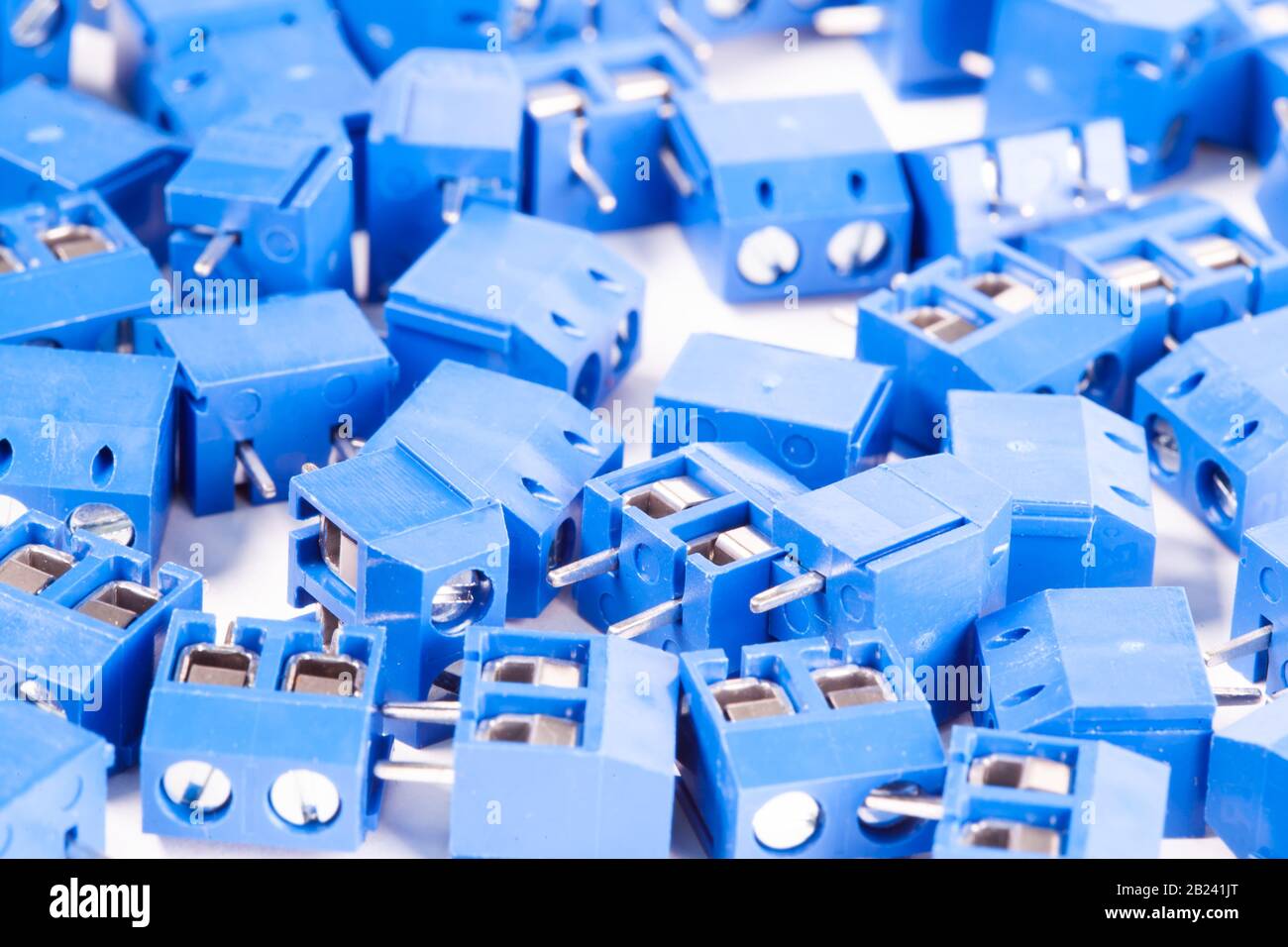 Close-up small blue connector parts lie on a white background. Concept ...