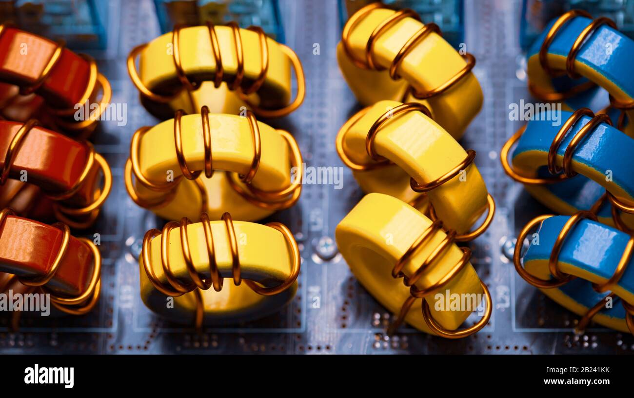 Top view close-up of blue yellow and red coils wrapped in copper wire ...