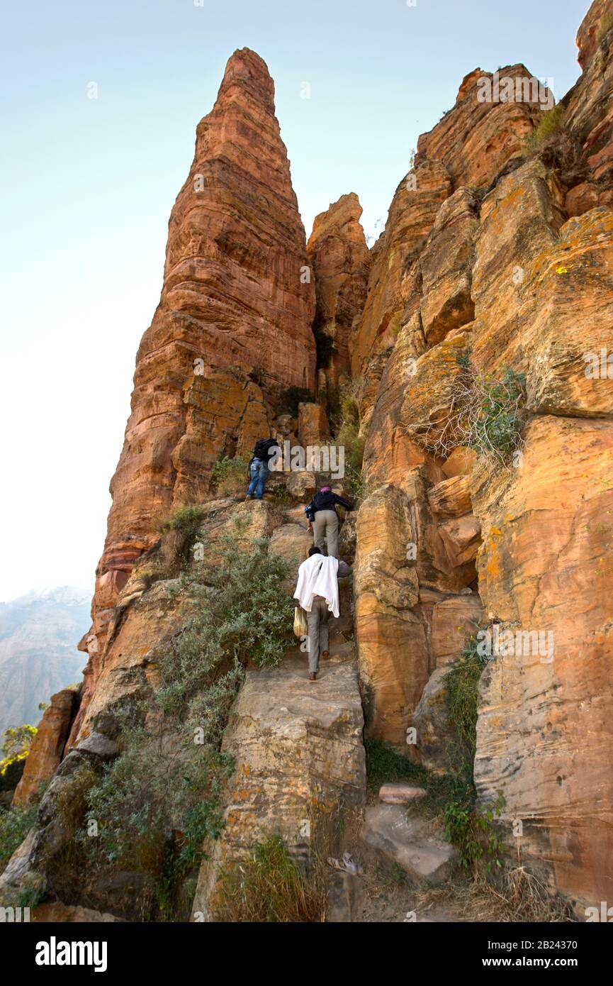 Visitors and local priest ascending the Guh pinnacle on the way to the ...