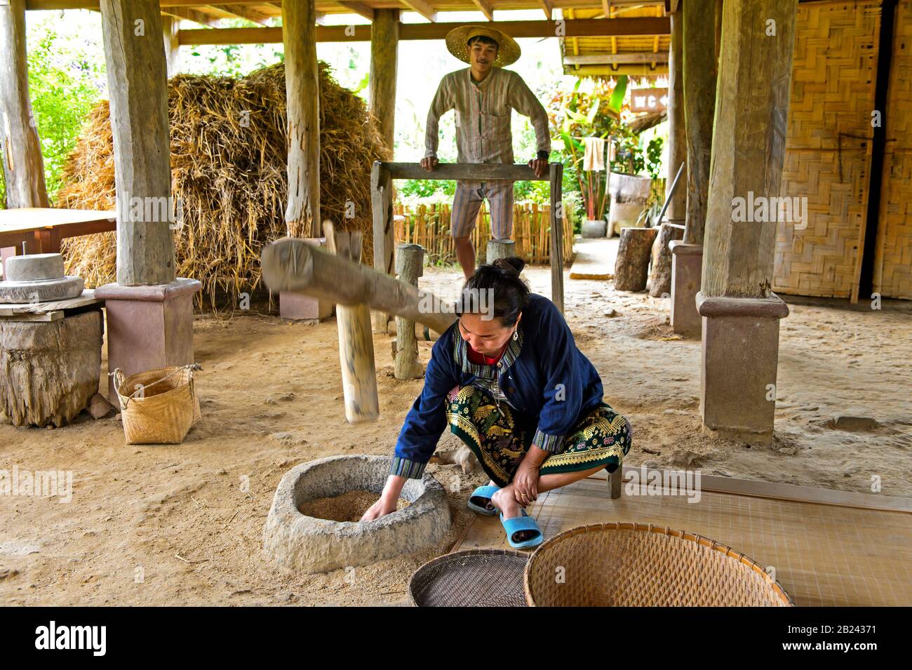 Traditional process of husking rice hi-res stock photography and images ...