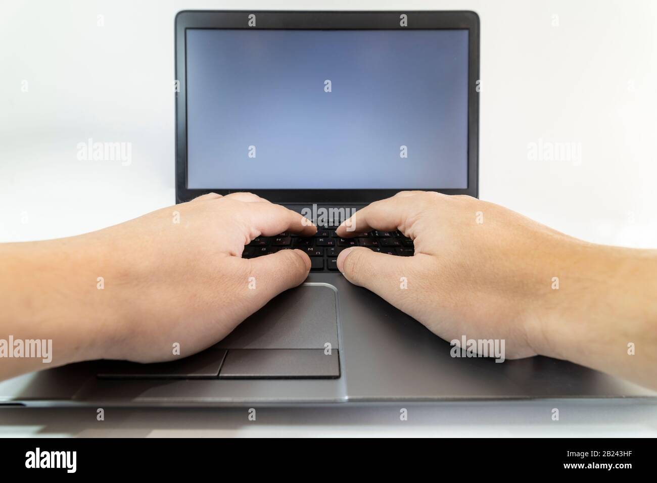 Low angle pow view of a man typing on a laptop keyboard Stock Photo - Alamy