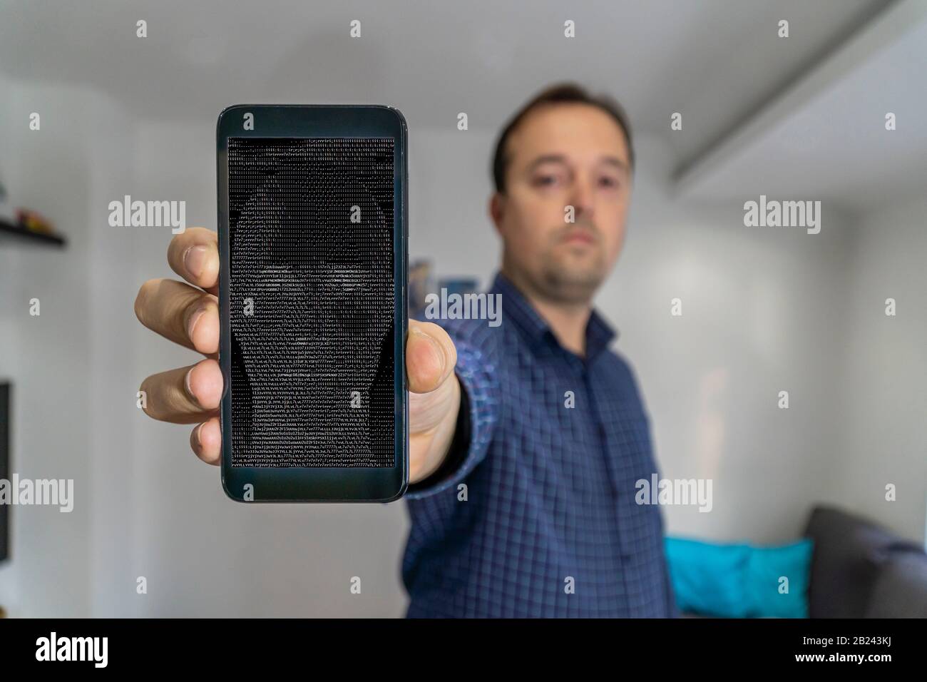 Man shwing smartphone to the camera with AI bot face on the screen ...