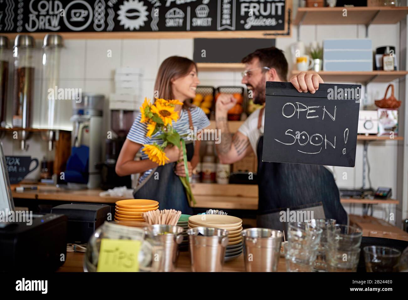 Coffee bar is open - Happy owner with open sign in their cafe store ...