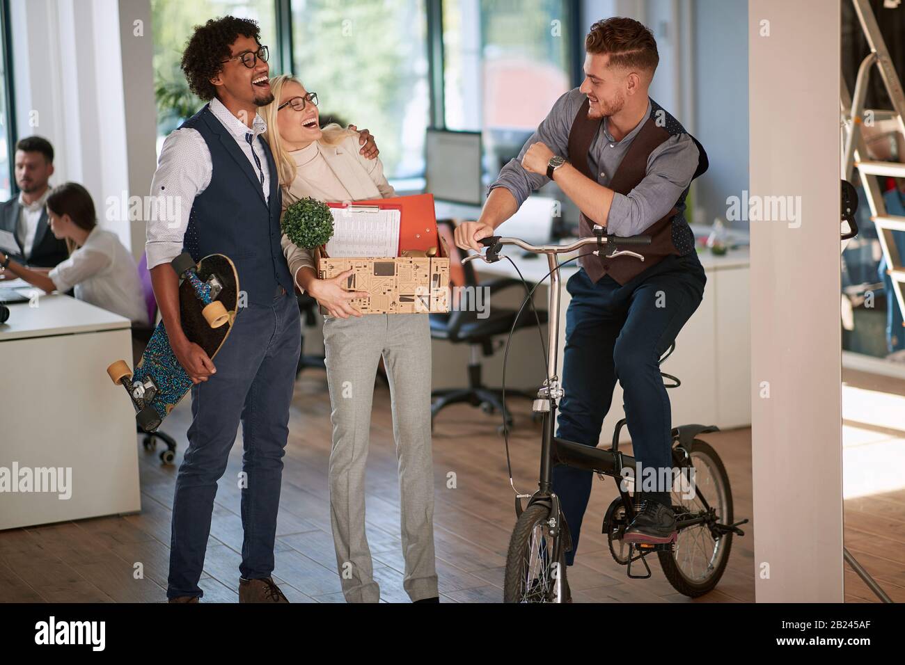 Modern startup company.Colleagues welcome woman at new work Stock Photo ...