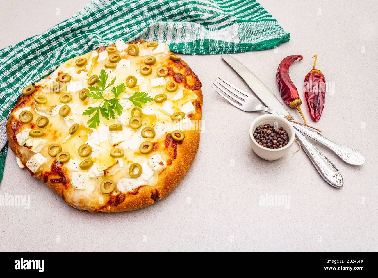 Italian focaccia with three types of cheese, green olives, hot chili ...