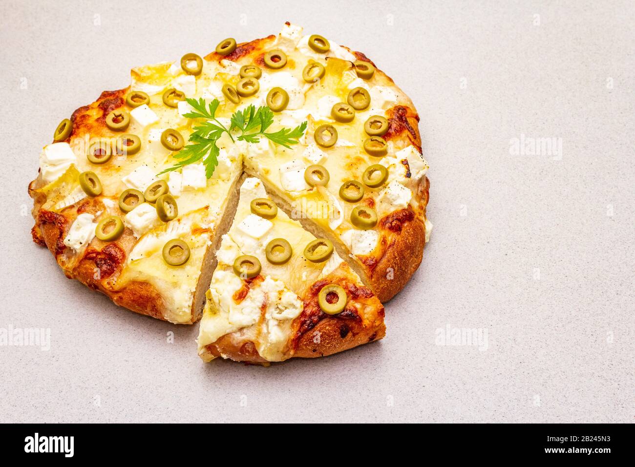 Italian focaccia with three types of cheese, green olives and parsley ...