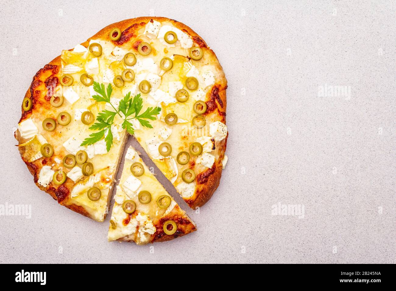 Italian focaccia with three types of cheese, green olives and parsley ...