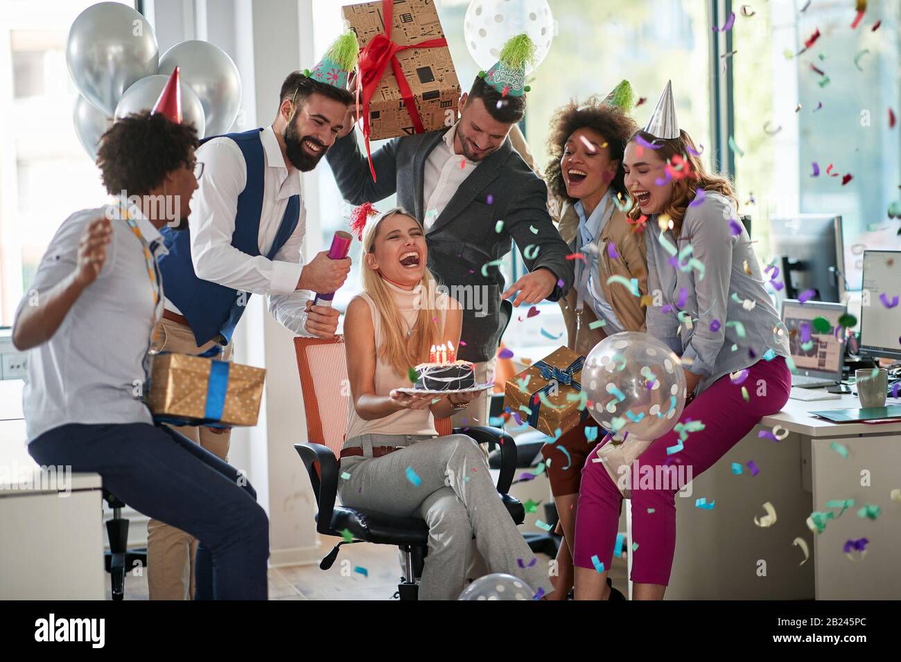 Celebrating a colleague's birthday in the office together.Happy ...