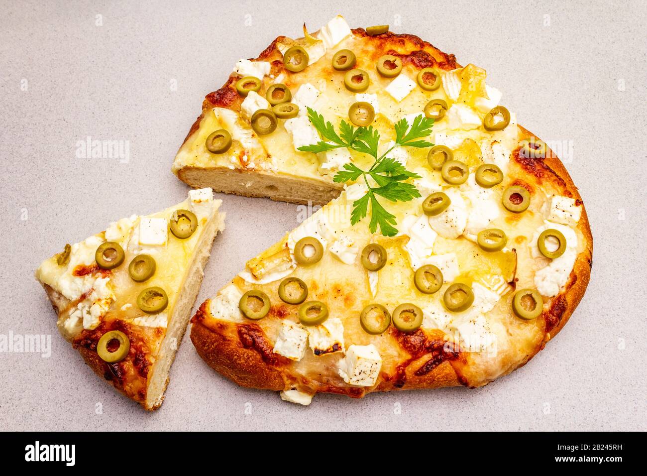 Italian focaccia with three types of cheese, green olives and parsley ...