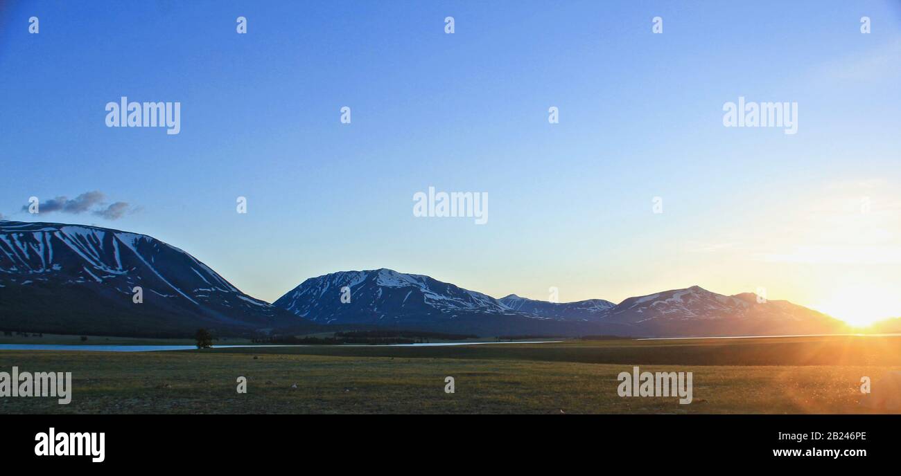 sunset of Mongolia behind of lake with grass and mountains Stock Photo ...