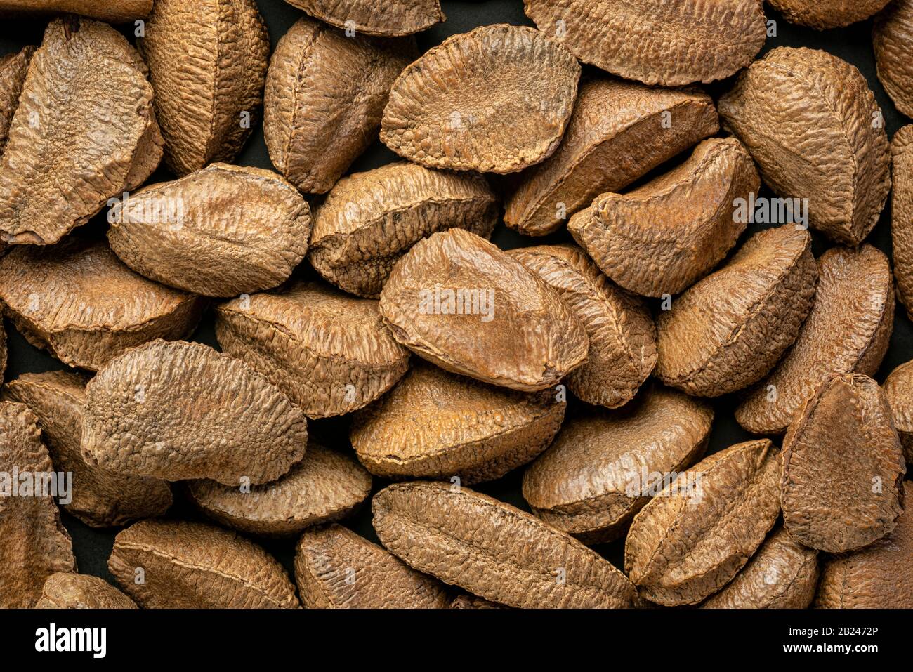 Brazilian nuts in shells against dark background, superfood concept ...