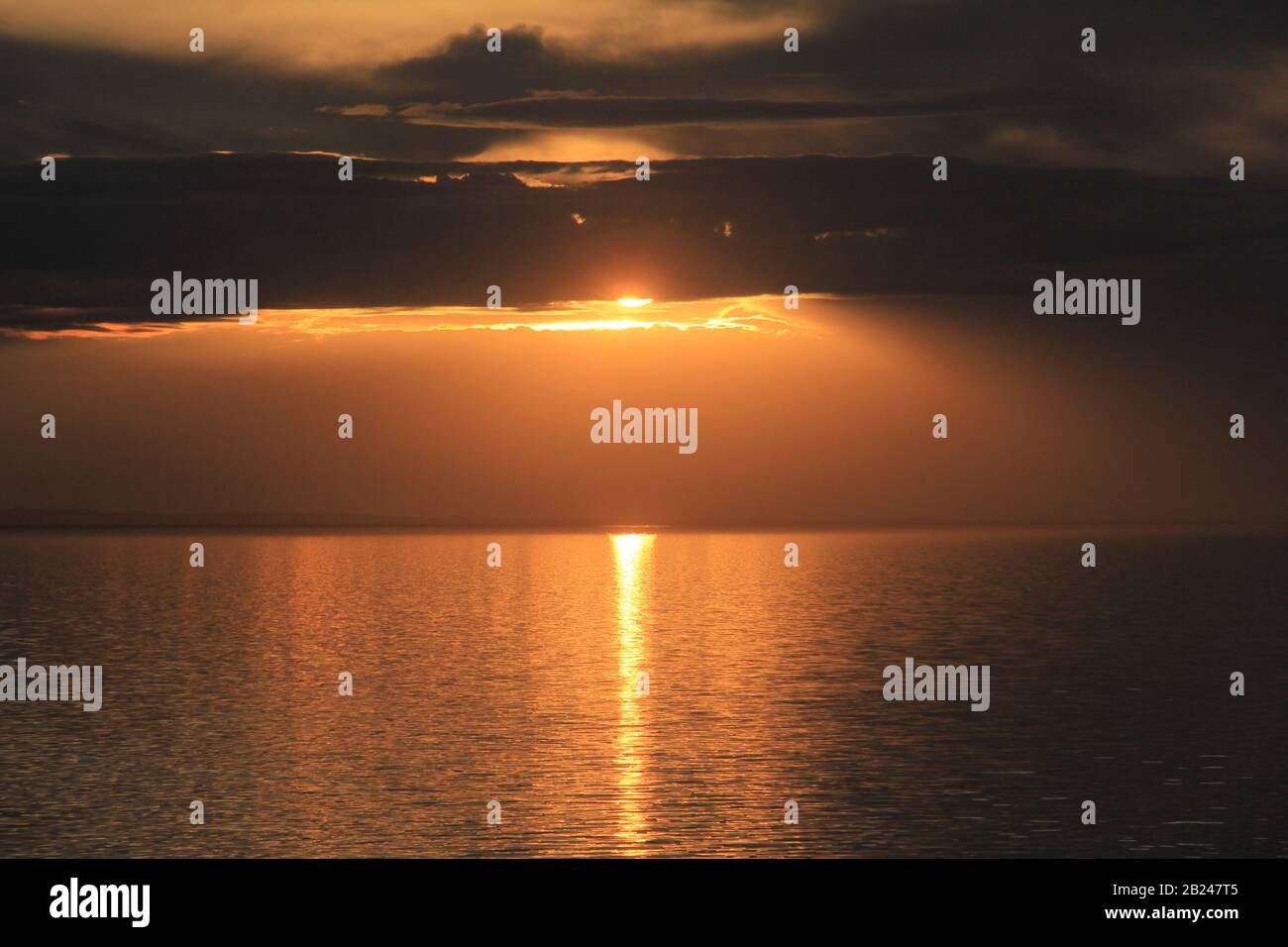 sunset of Mongolia behind of lake with grass and mountains Stock Photo ...