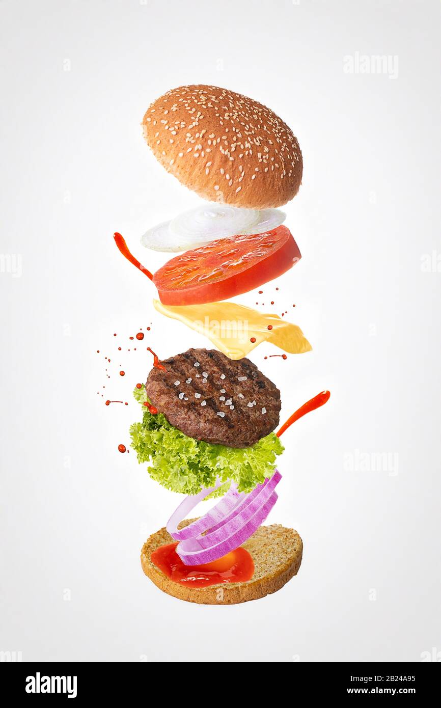Hamburger with floating layers on light background Stock Photo - Alamy