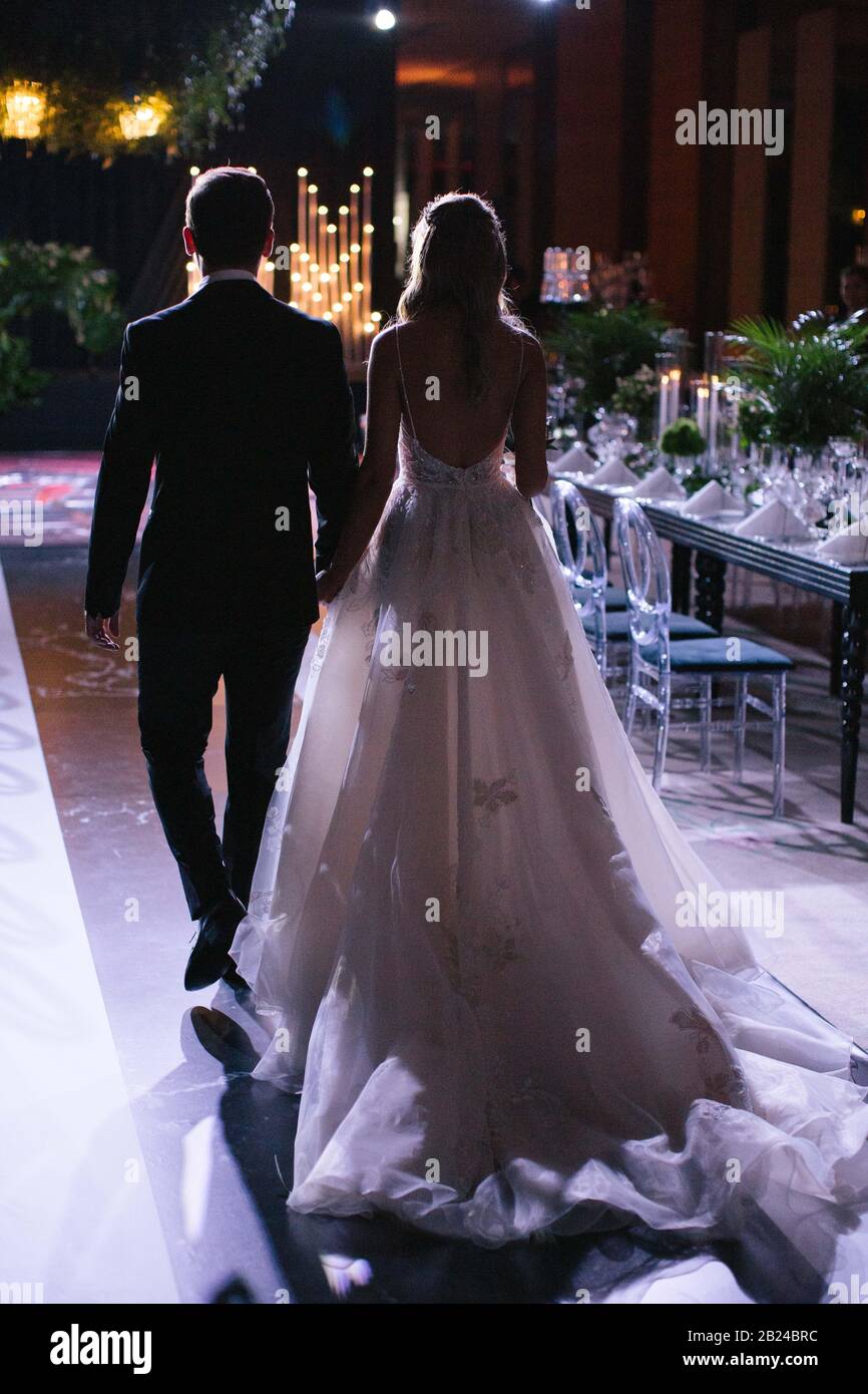 The bride and groom walk side by side and hand in hand Stock Photo - Alamy