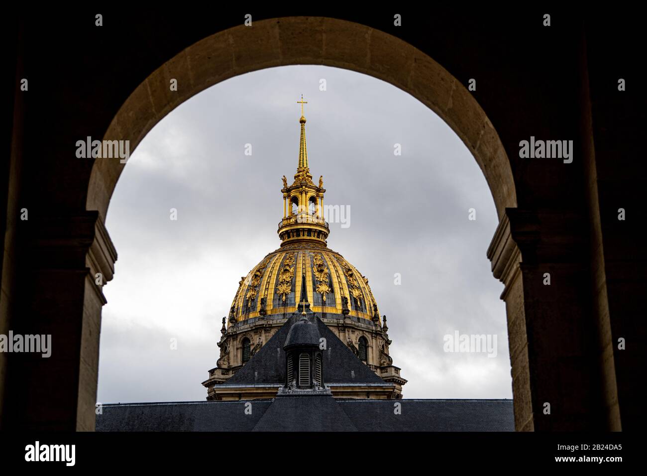 The golden dome of Les Invalides viewed from under the entrance archway ...