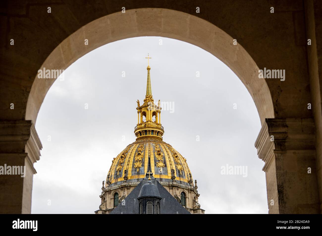 The golden dome of Les Invalides viewed from under the entrance archway ...