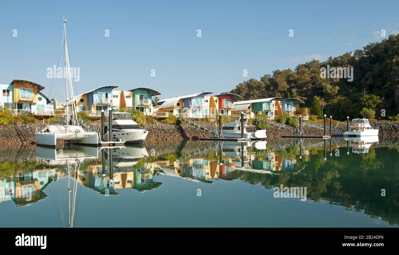 Waterfront maritime marina/dock with boats in tropical water with blue ...