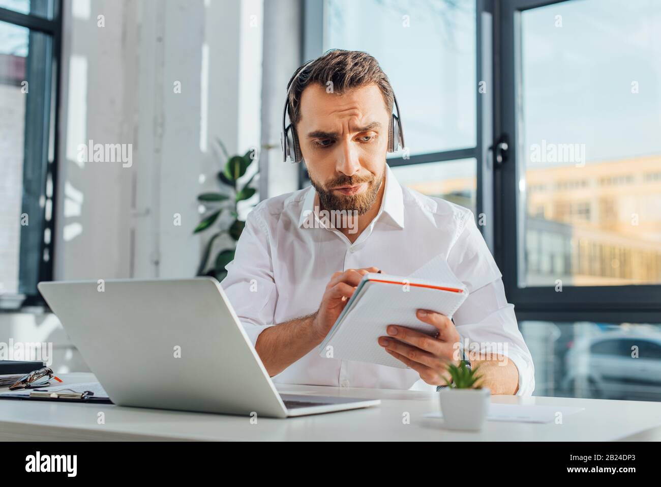 professional translator writing and working online with headphones and ...