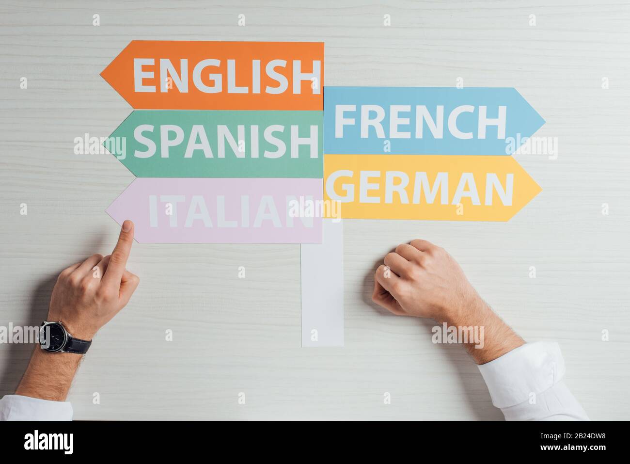 top view of translator pointing at arrows with languages Stock Photo ...